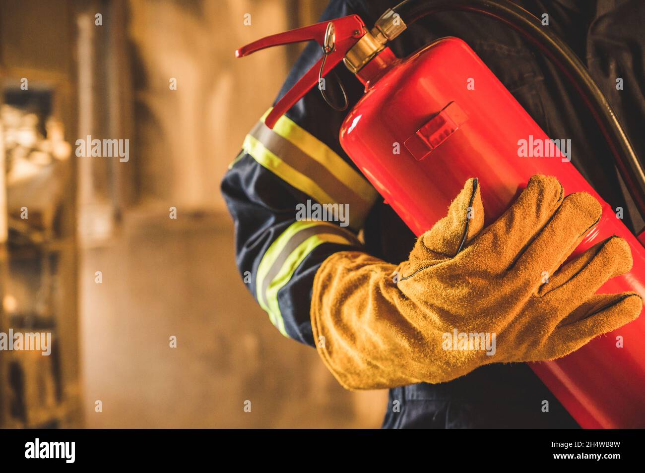 Close up hand Fireman,Firefighter holding the fire extinguisher Stock ...