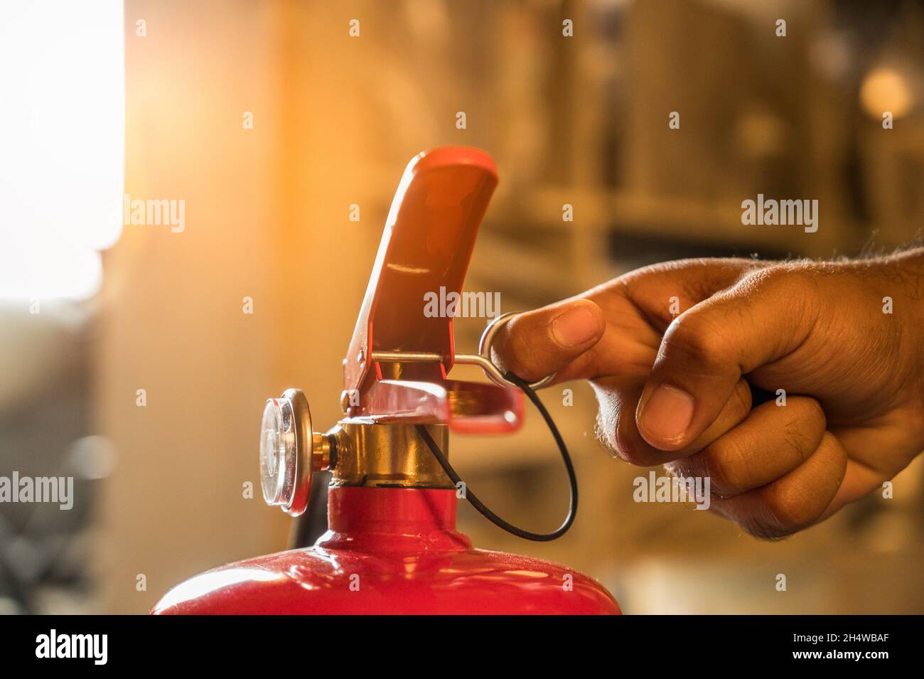 Close up hand Fireman using fire extinguisher fighting. Hand pulling ...