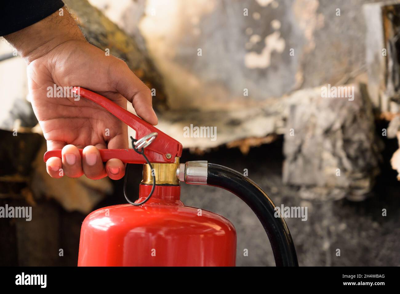 Close up hand Fireman using fire extinguisher fighting Stock Photo - Alamy