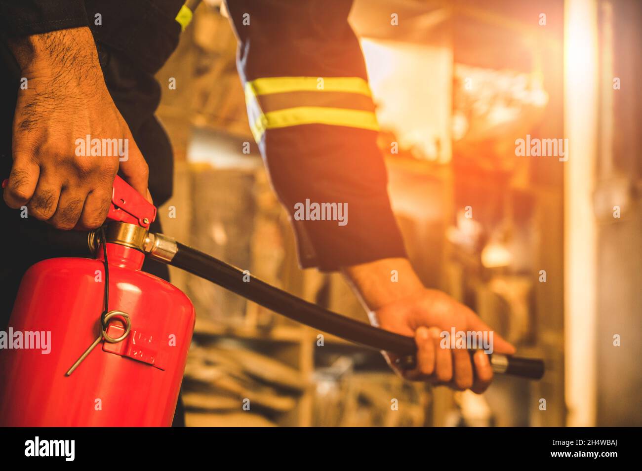 Close up hand Fireman using fire extinguisher fighting Stock Photo - Alamy