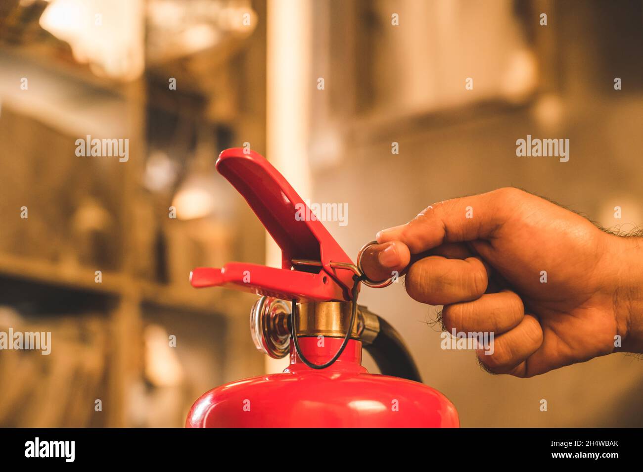 Close up hand Fireman using fire extinguisher fighting. Hand pulling ...