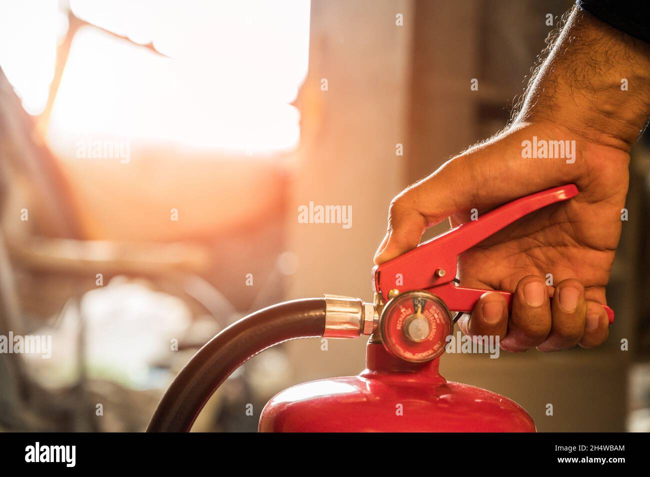 Close up hand Fireman using fire extinguisher fighting Stock Photo - Alamy