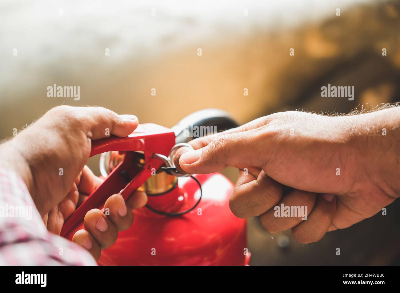 Close up hand Fireman using fire extinguisher fighting. Hand pulling ...