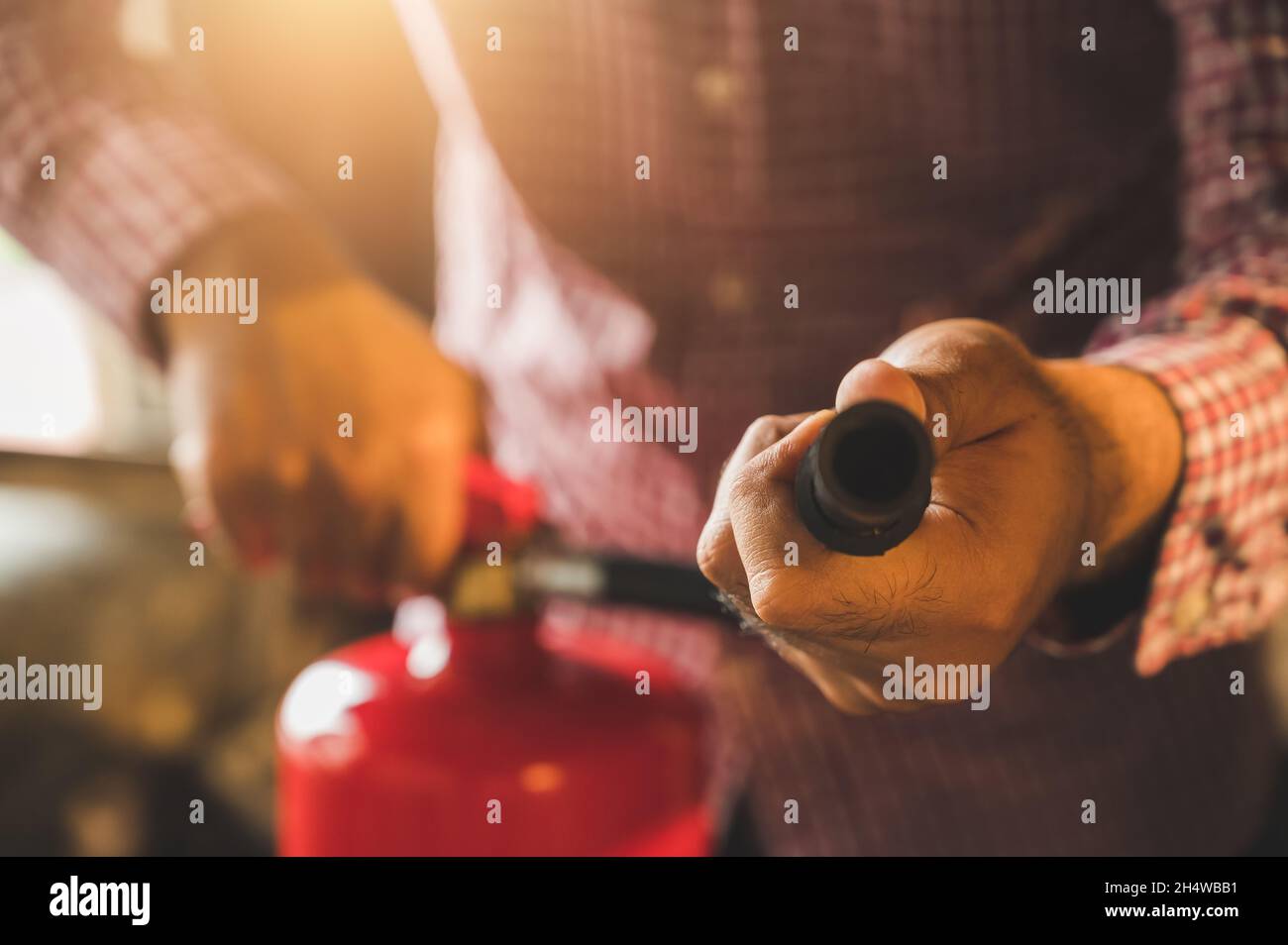 Close up hand Fireman using fire extinguisher fighting Stock Photo - Alamy