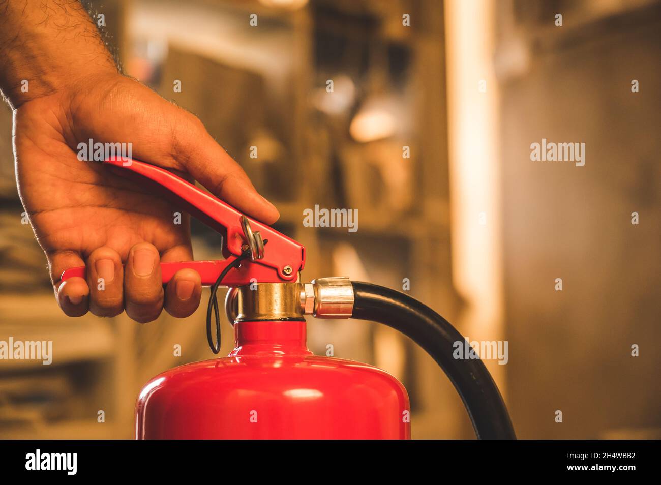 Close up hand Fireman using fire extinguisher fighting Stock Photo - Alamy
