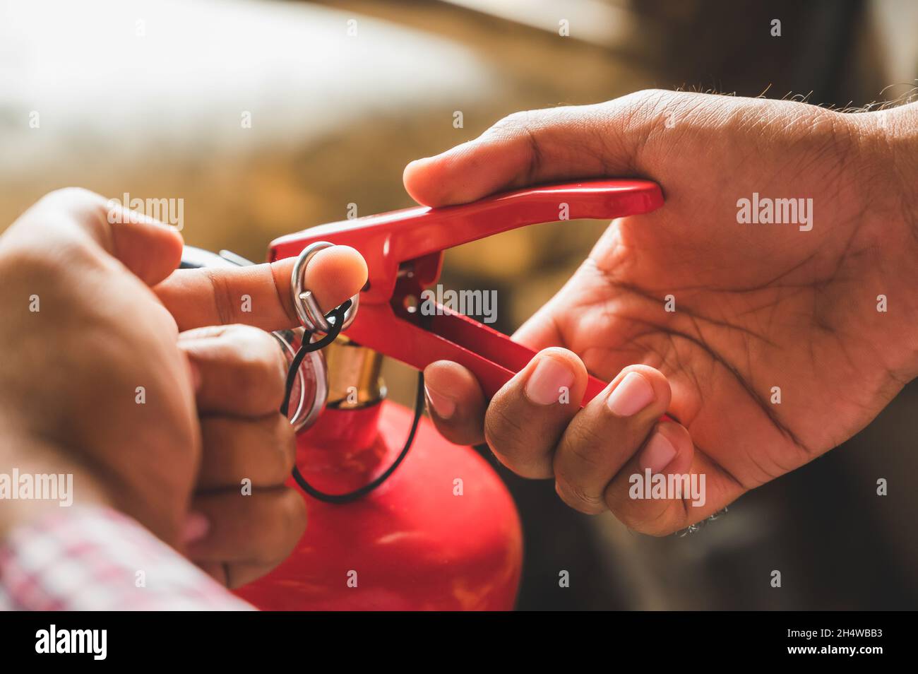Close up hand Fireman using fire extinguisher fighting. Hand pulling ...
