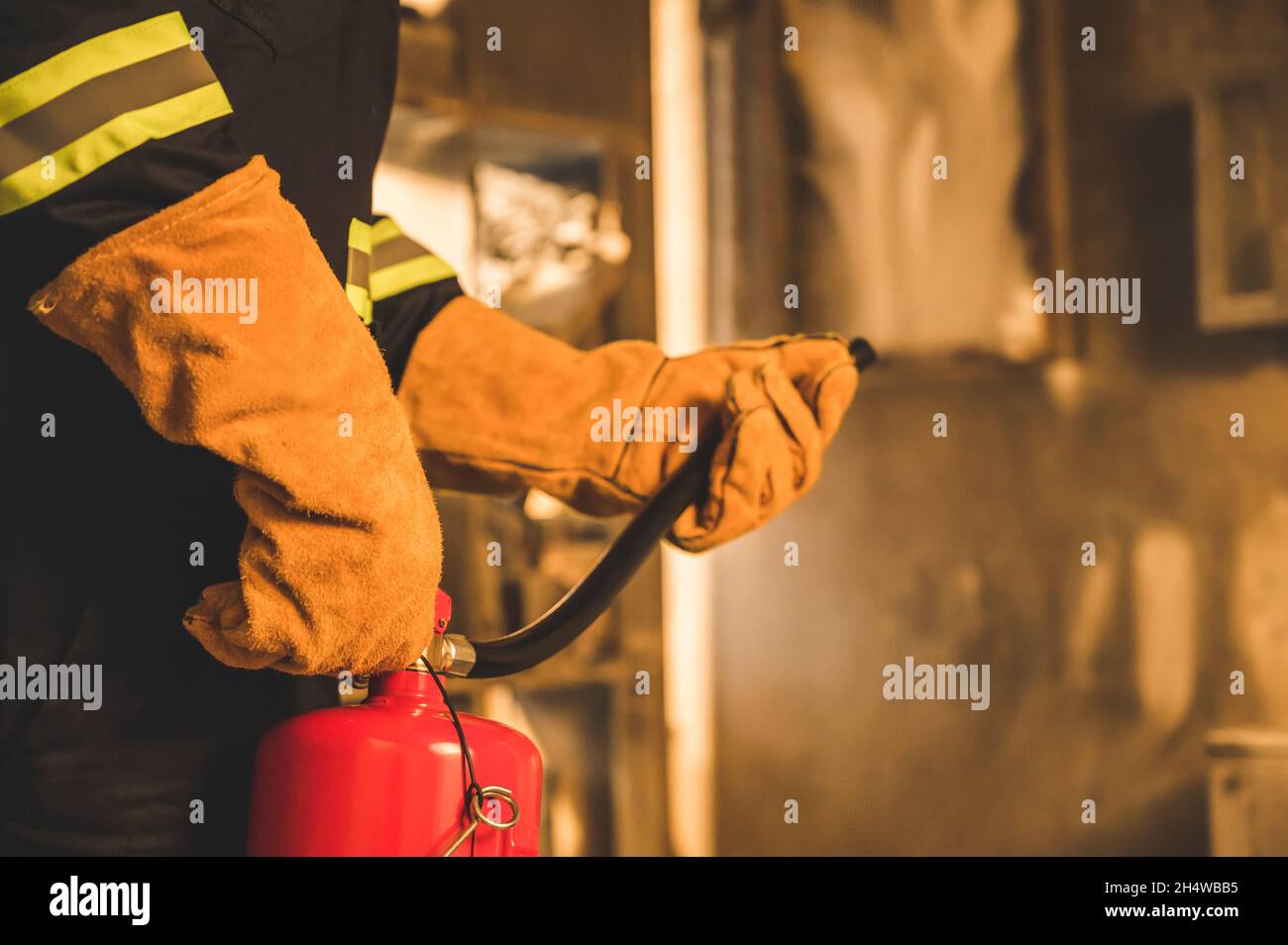 Close up hand Fireman using fire extinguisher fighting Stock Photo - Alamy