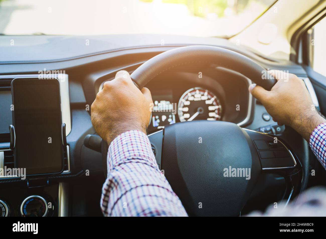 Close up front view hands hold steering wheel. Driving car concept ...