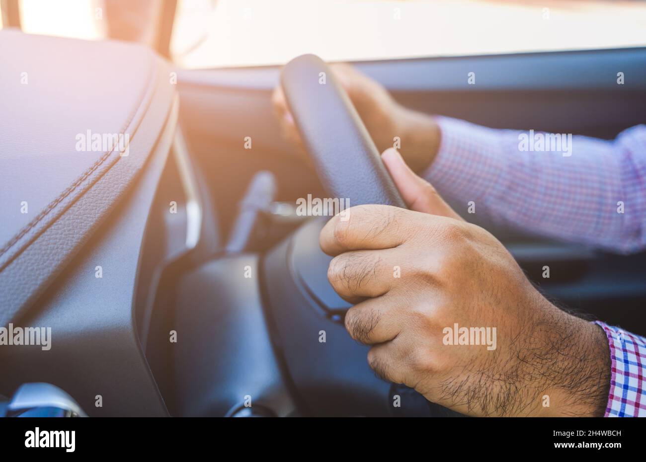 Close up front view hands hold steering wheel. Driving car concept ...