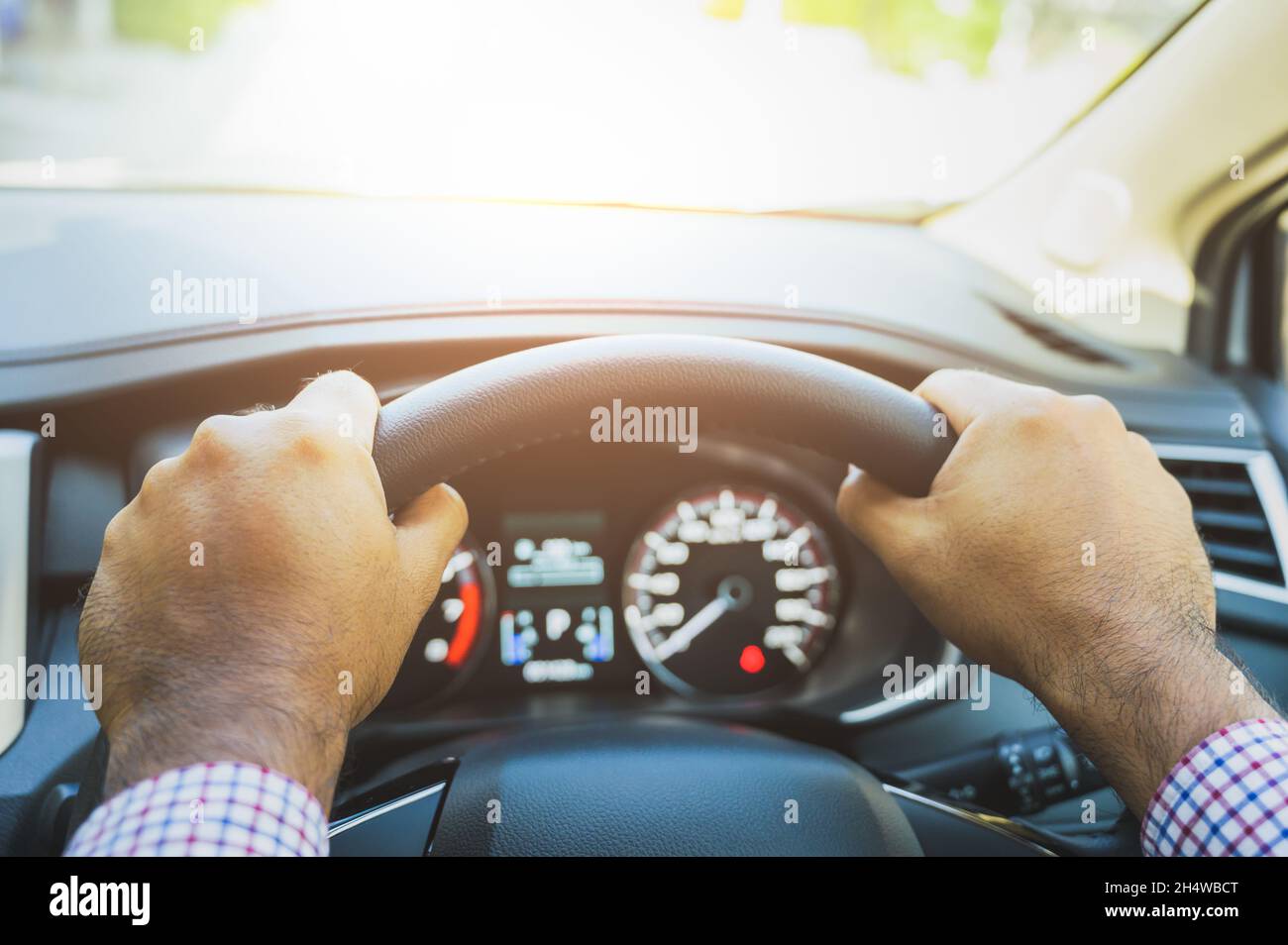 Close up front view hands hold steering wheel. Driving car concept ...
