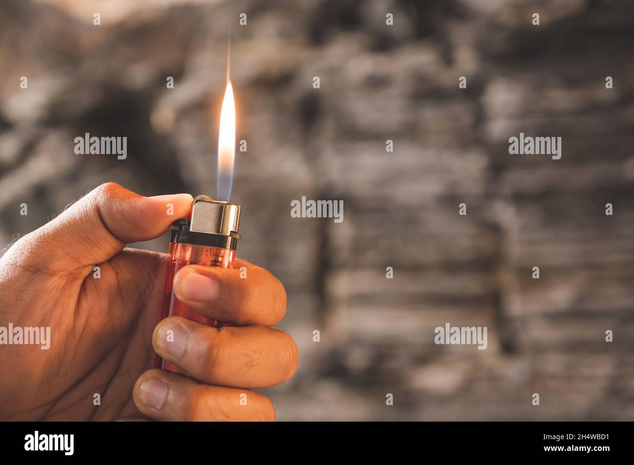 Thumb on lighter hi-res stock photography and images - Alamy