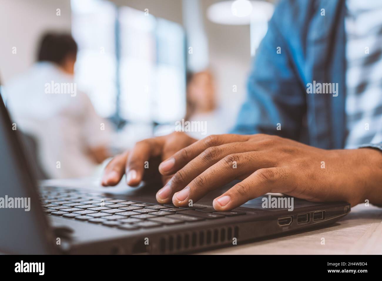 Close up hands tapping keyboard on laptop Stock Photo - Alamy