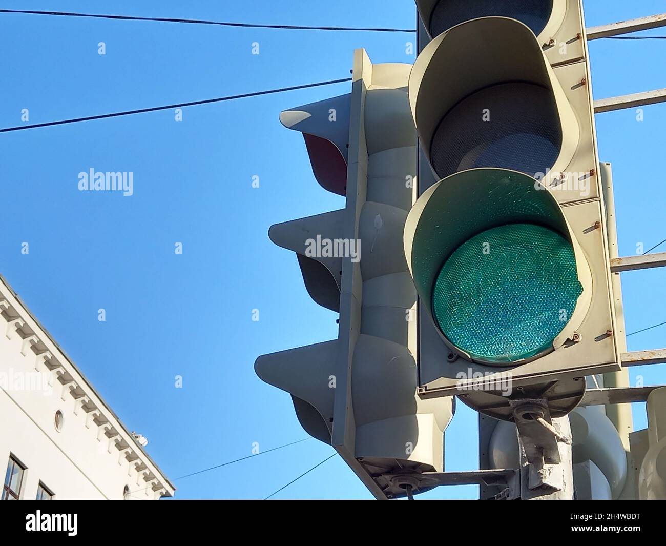Traffic light on a post near the roadway. Regulated pedestrian crossing ...