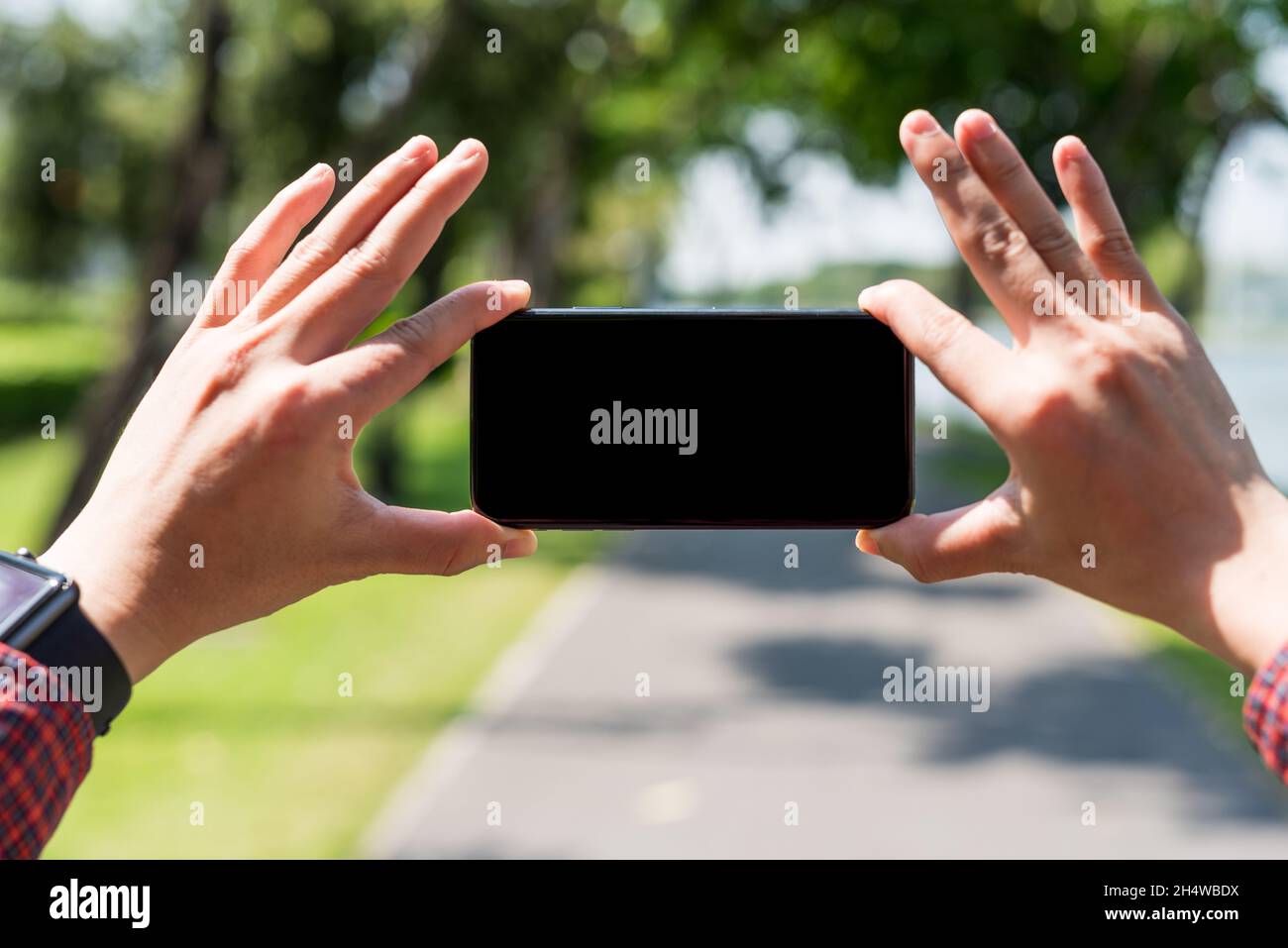 Hand holding smartphone to take video hi-res stock photography and ...