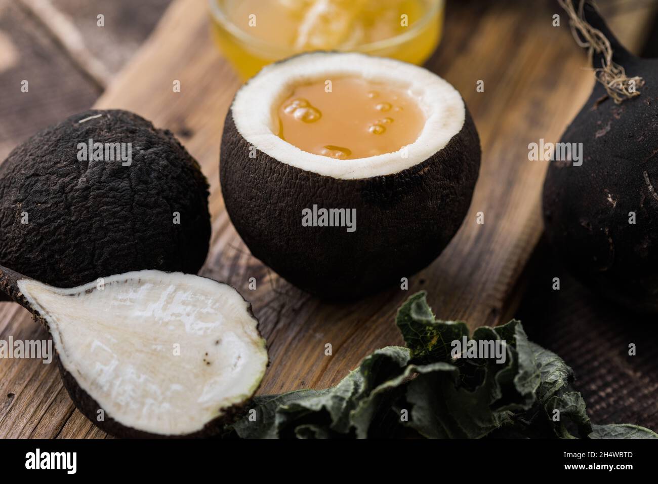 Organic raw Black radish with honey on wooden table. Homemade cough ...