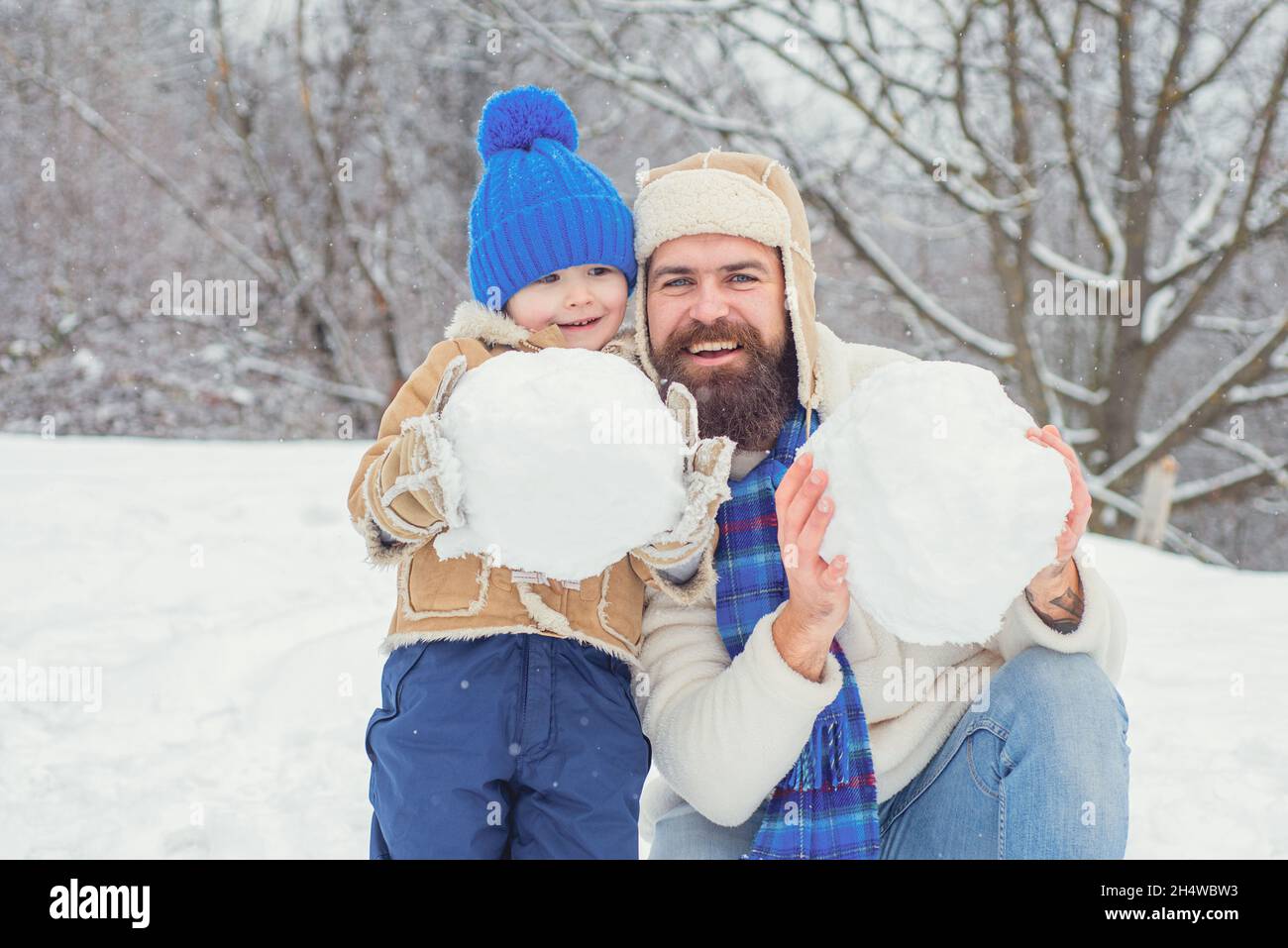 Winter, father and son play outdoor. Happy father and son making ...