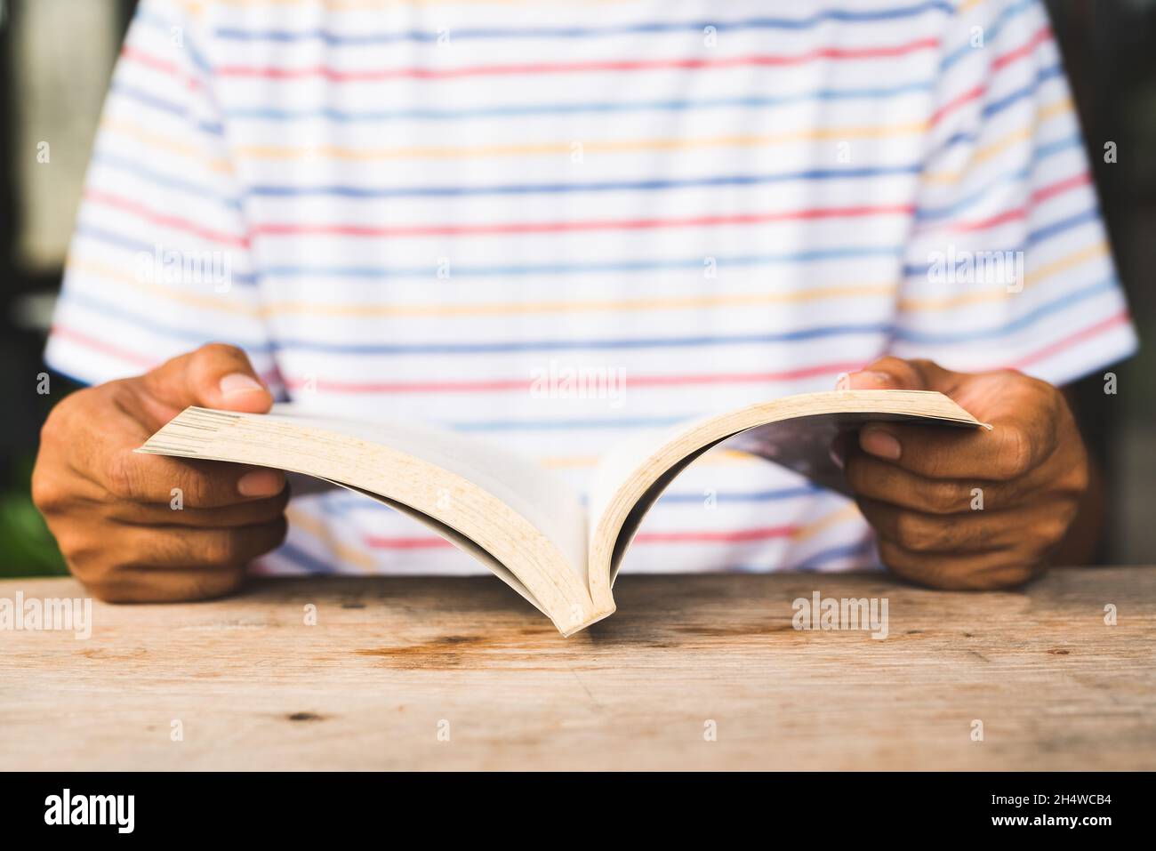 Close up man reading a book Stock Photo - Alamy