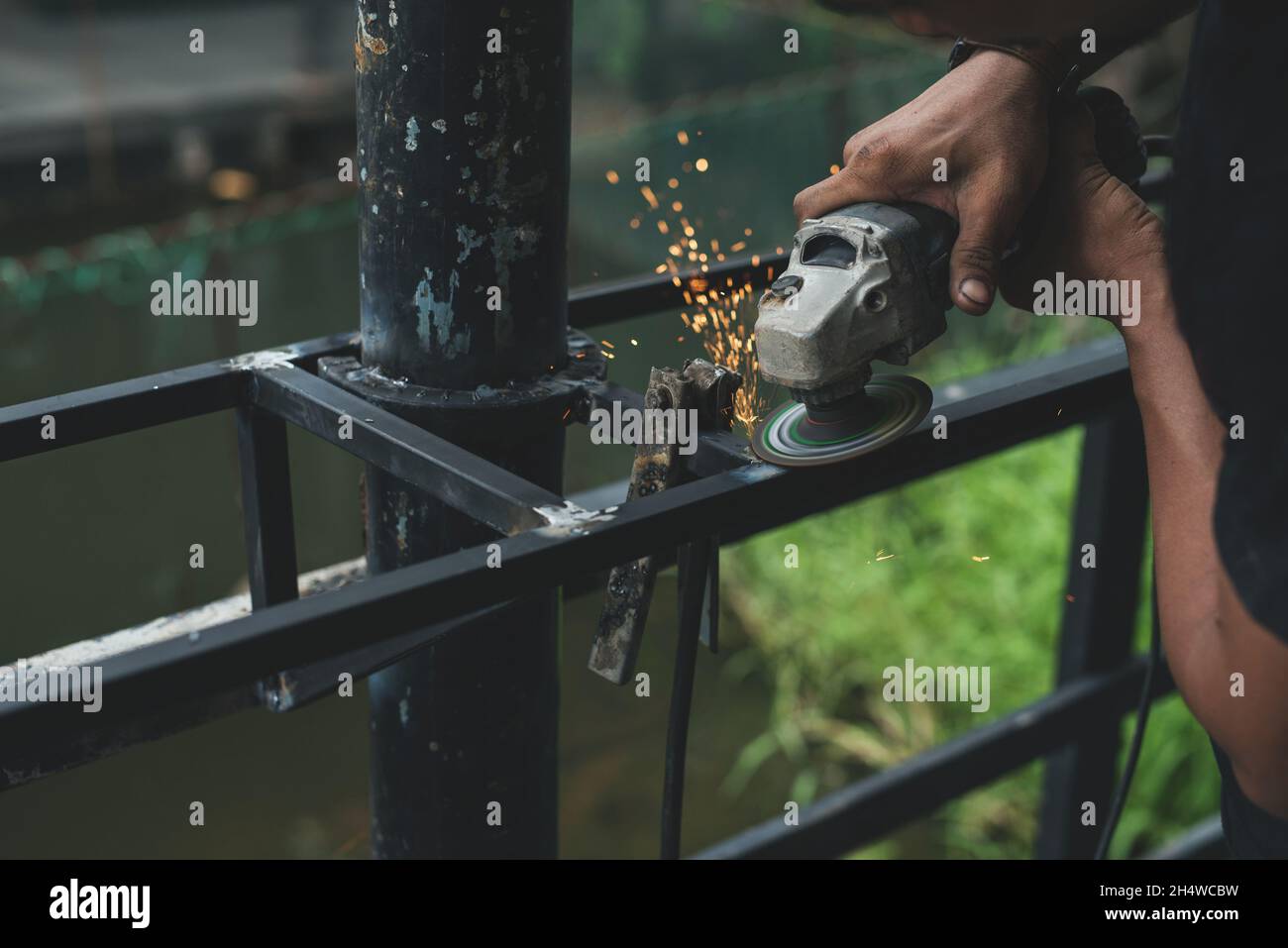 Close up worker using machine cutting steel Stock Photo - Alamy