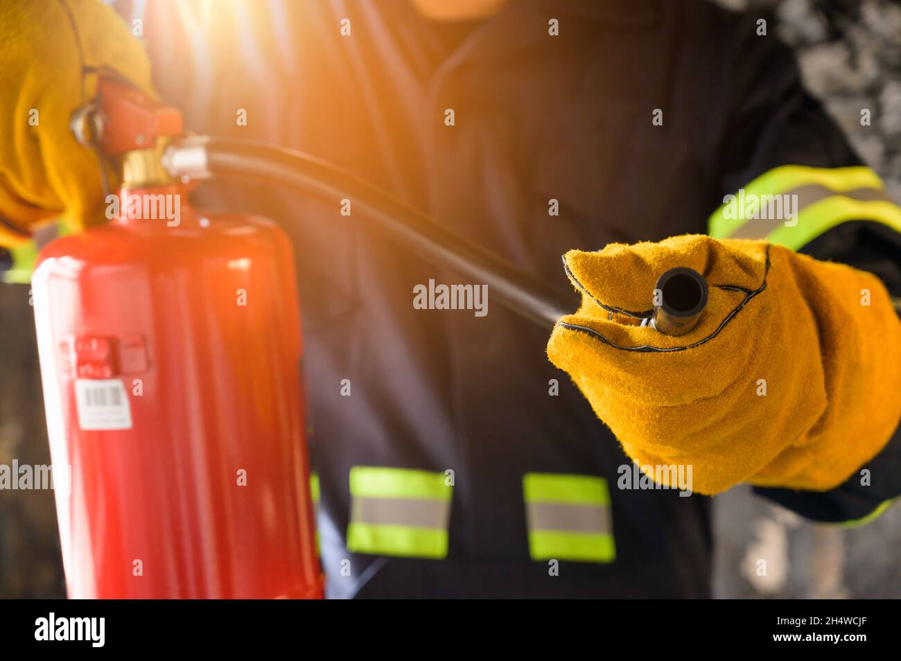 Close up hand Fireman using fire extinguisher fighting Stock Photo - Alamy