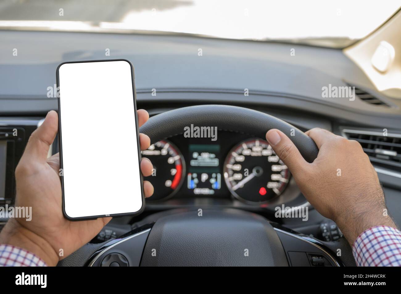 Hand holding blank screen of smartphone while driving car Stock Photo ...