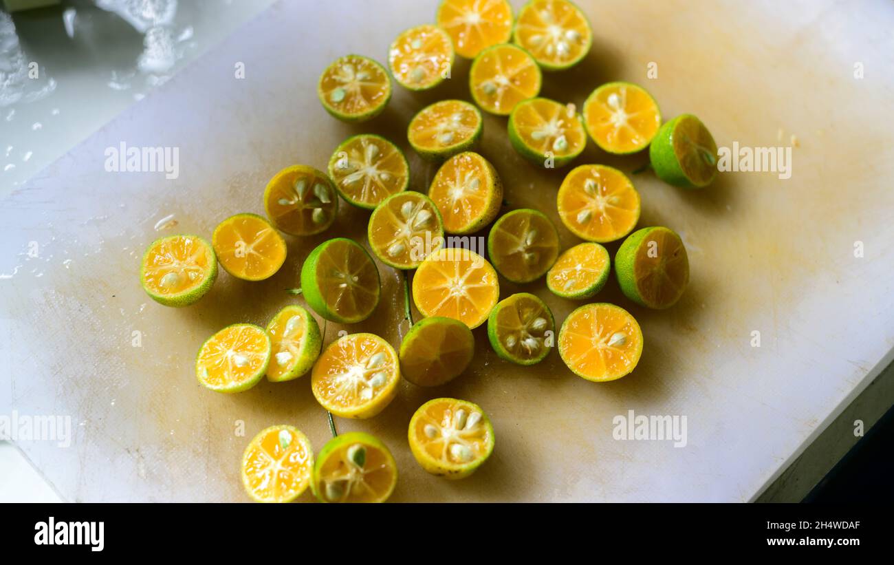 Sri Lankan variety of mandarin oranges unpeeled and cut into halves and ...