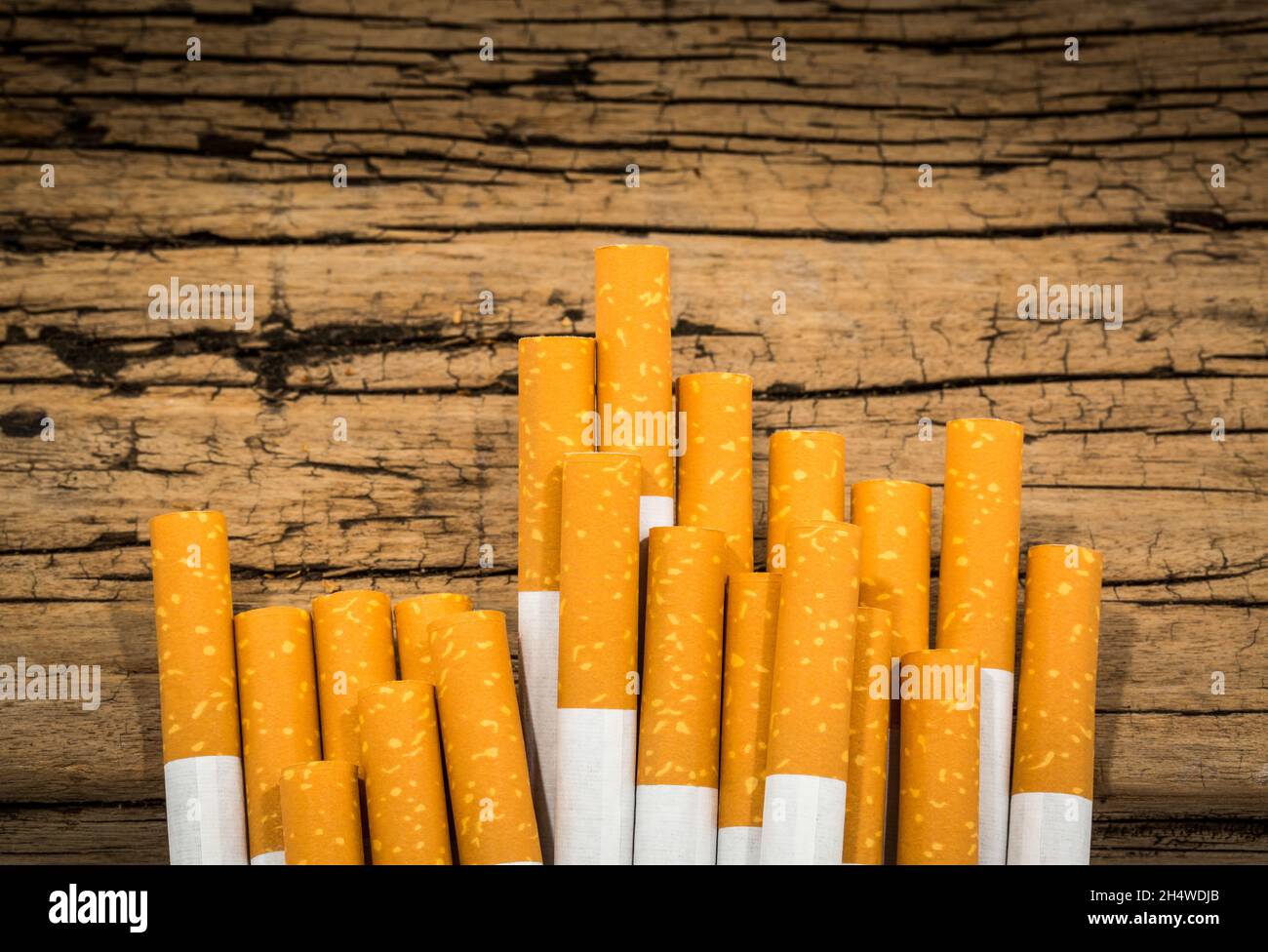 Stack of cigarette on wood table Stock Photo - Alamy