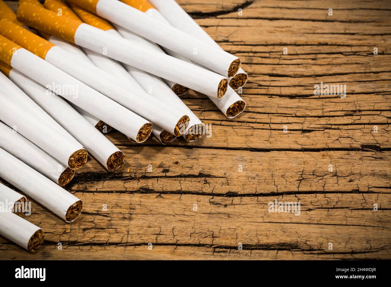 Stack of cigarette on wood table background Stock Photo - Alamy