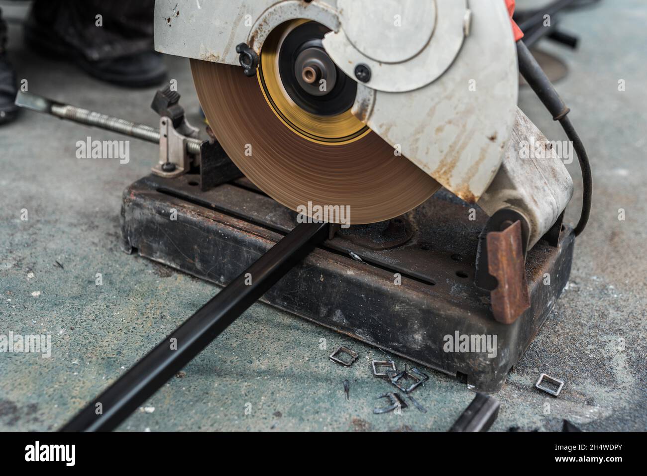 Worker man using machine cutting steel Stock Photo - Alamy