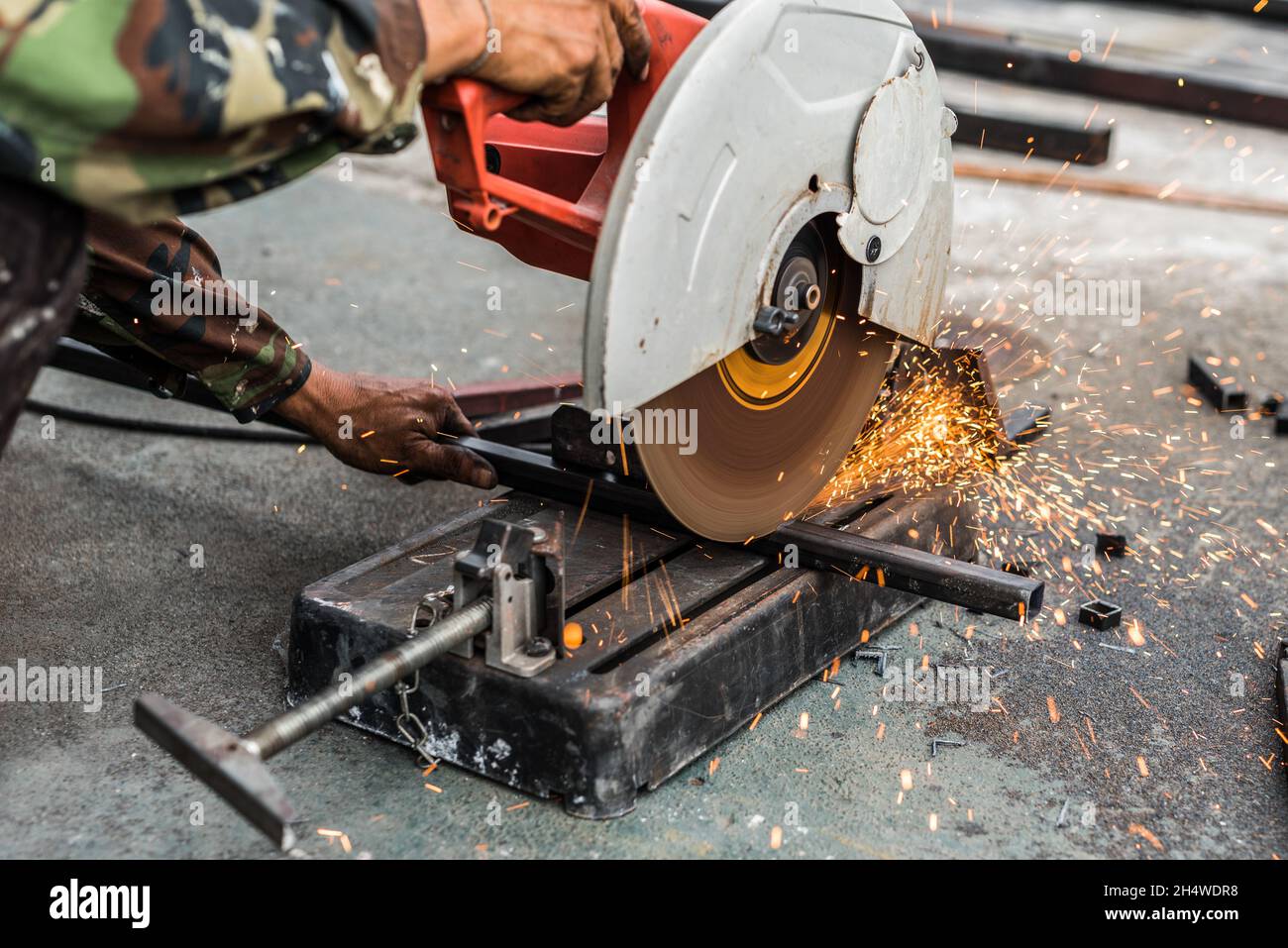 Worker man using machine cutting steel Stock Photo - Alamy