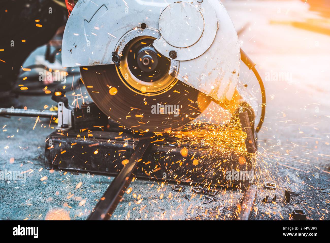 Worker man using machine cutting steel Stock Photo - Alamy