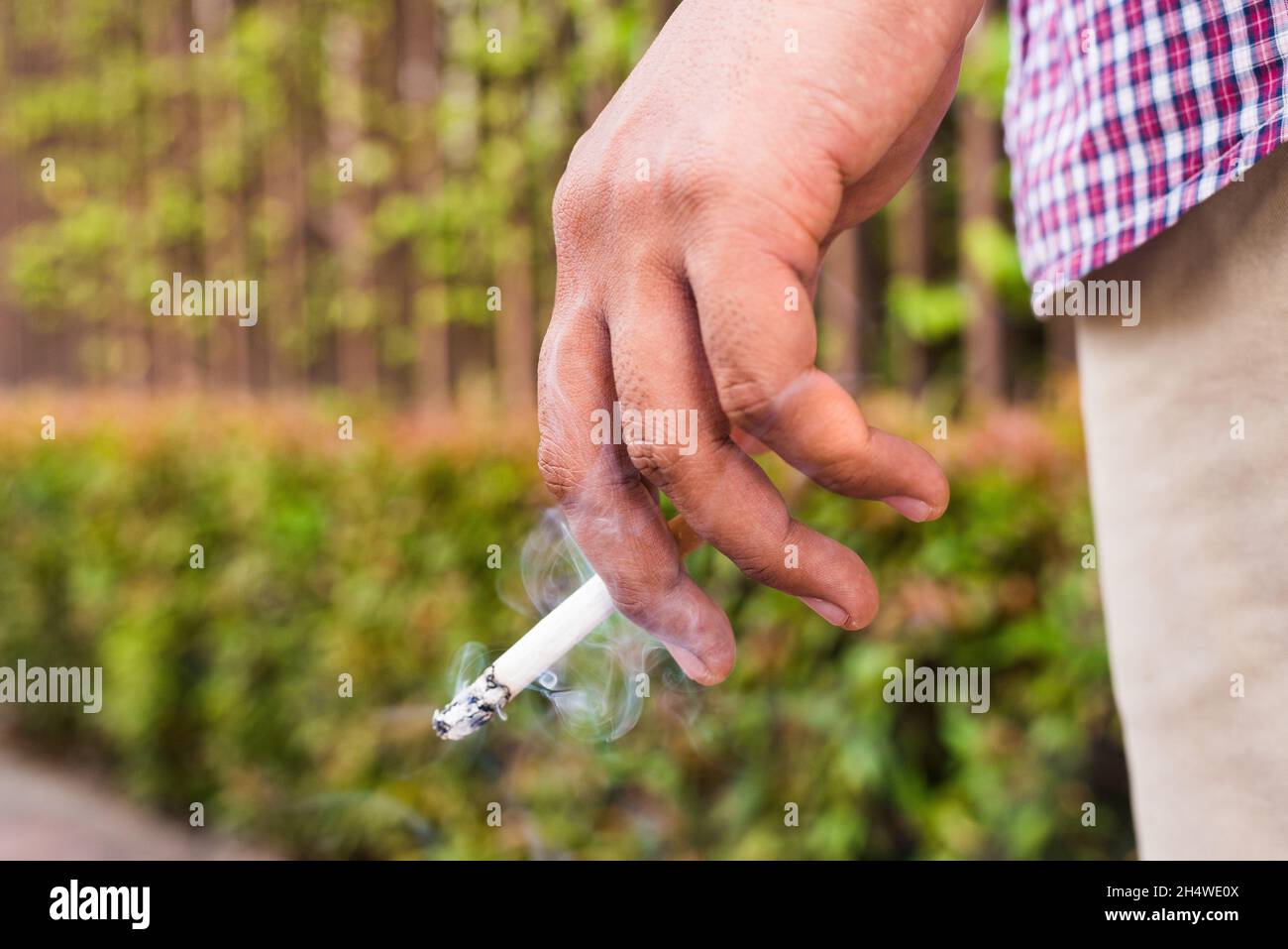 Young man Smoking cigarette.Man holding cigarette Stock Photo - Alamy