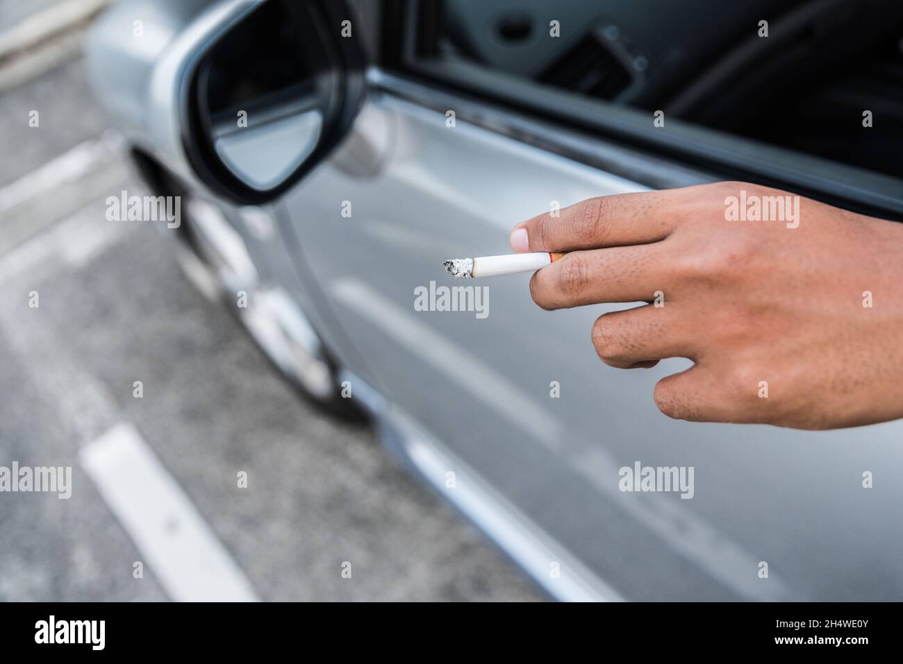 Young man smoking in car Stock Photo - Alamy