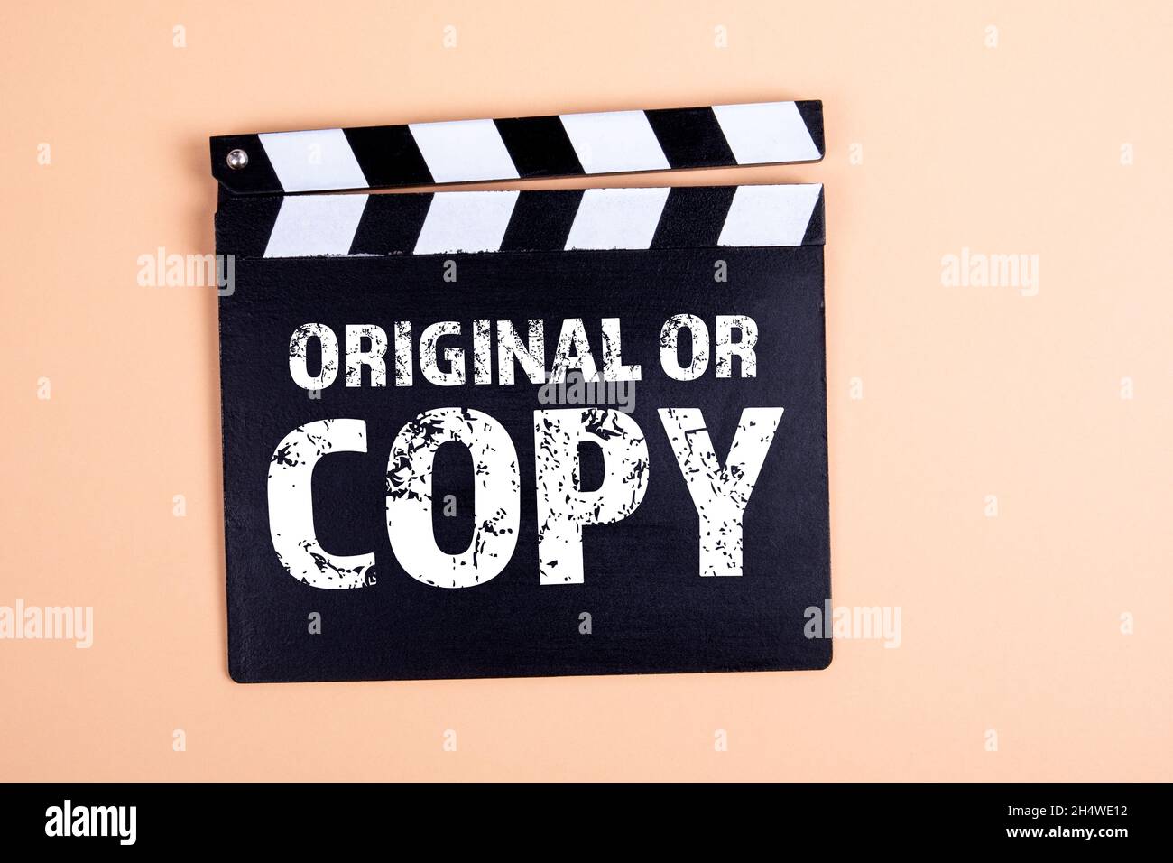 Original or Copy. Movie clapper board with text on a light background ...