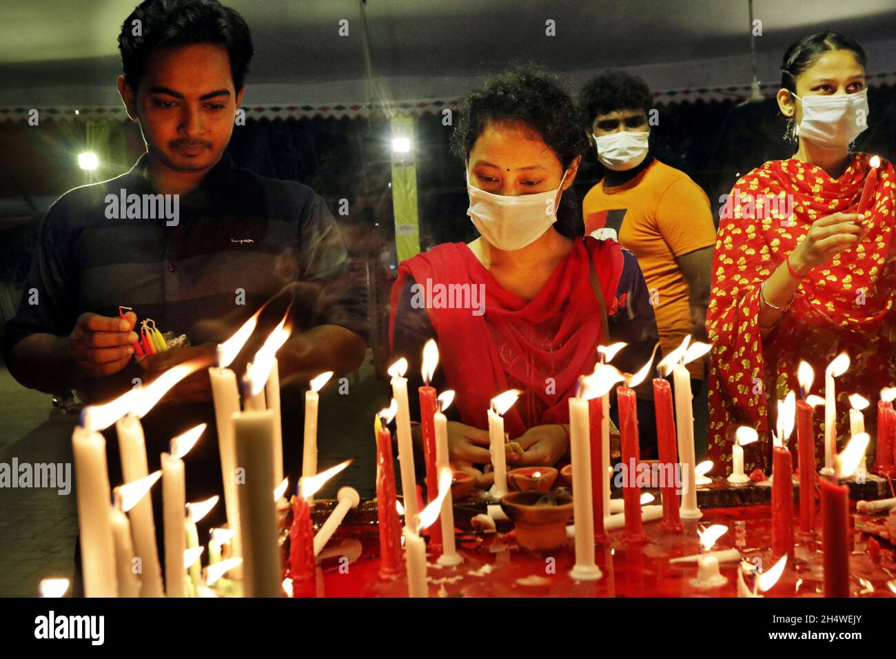 Dhaka, Bangladesh. 04th Nov, 2021. Devotees seen lighting candles as ...