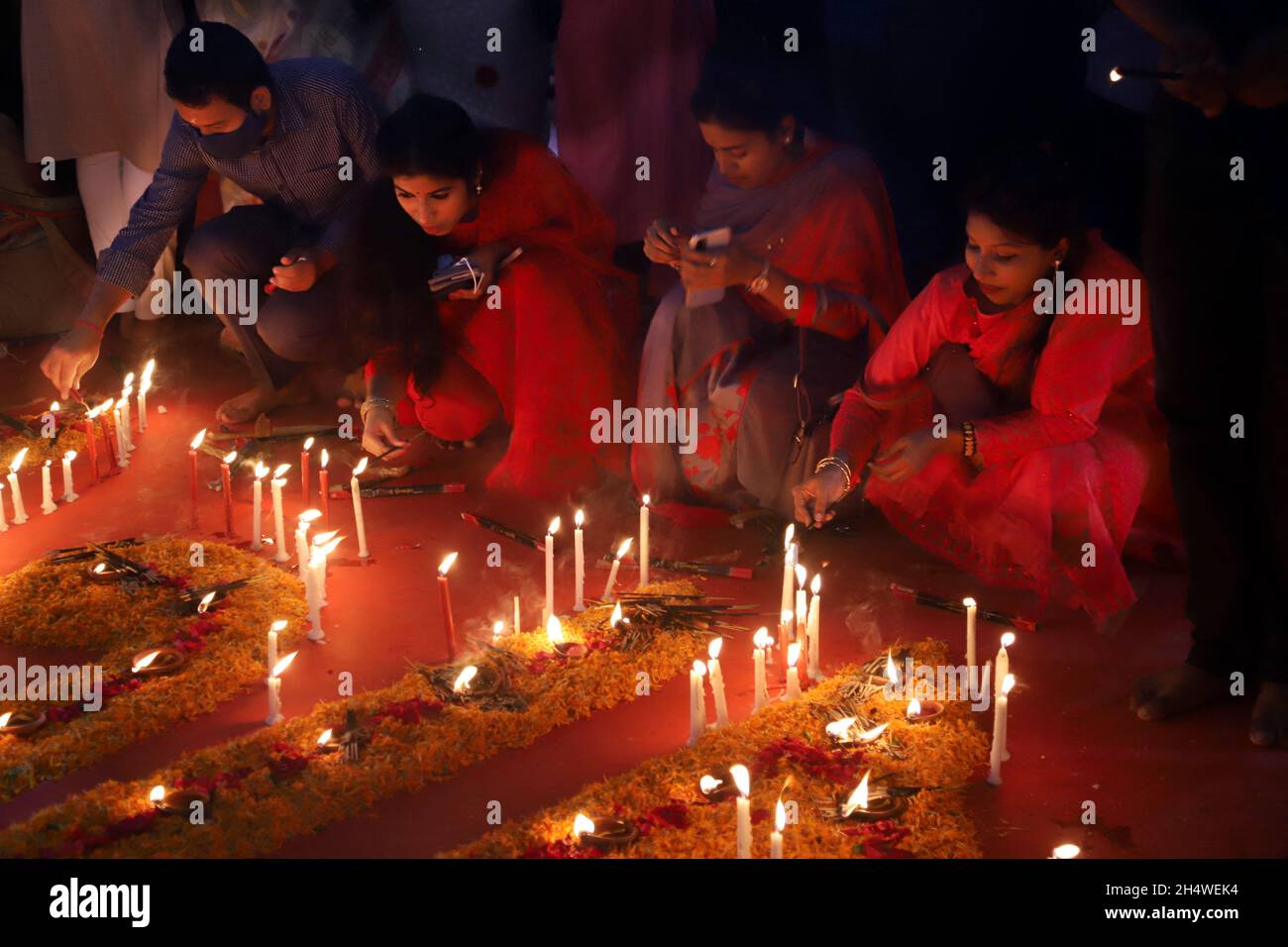 Dhaka, Bangladesh. 04th Nov, 2021. Devotees seen lighting candles as ...