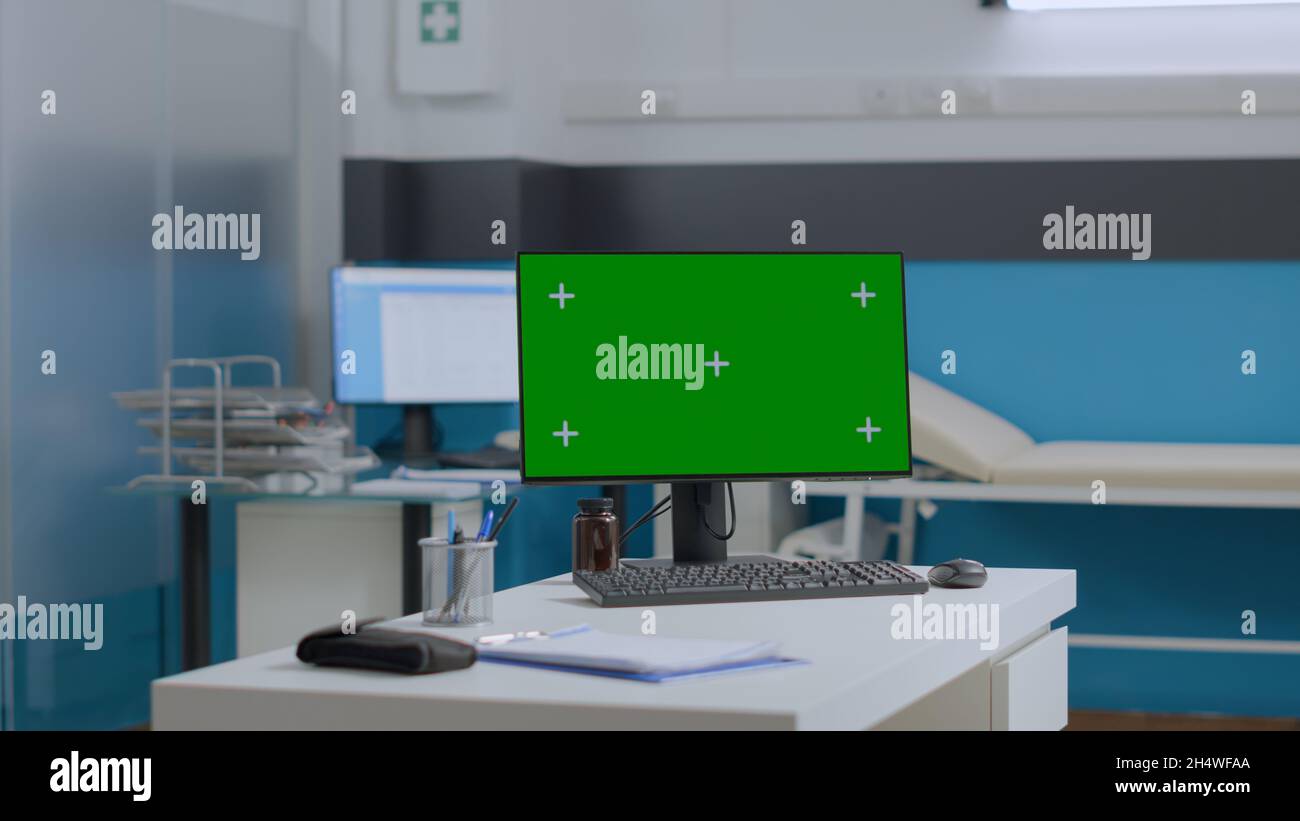 Closeup of mock up green screen chroma key computer with isolated display standing on table in ...