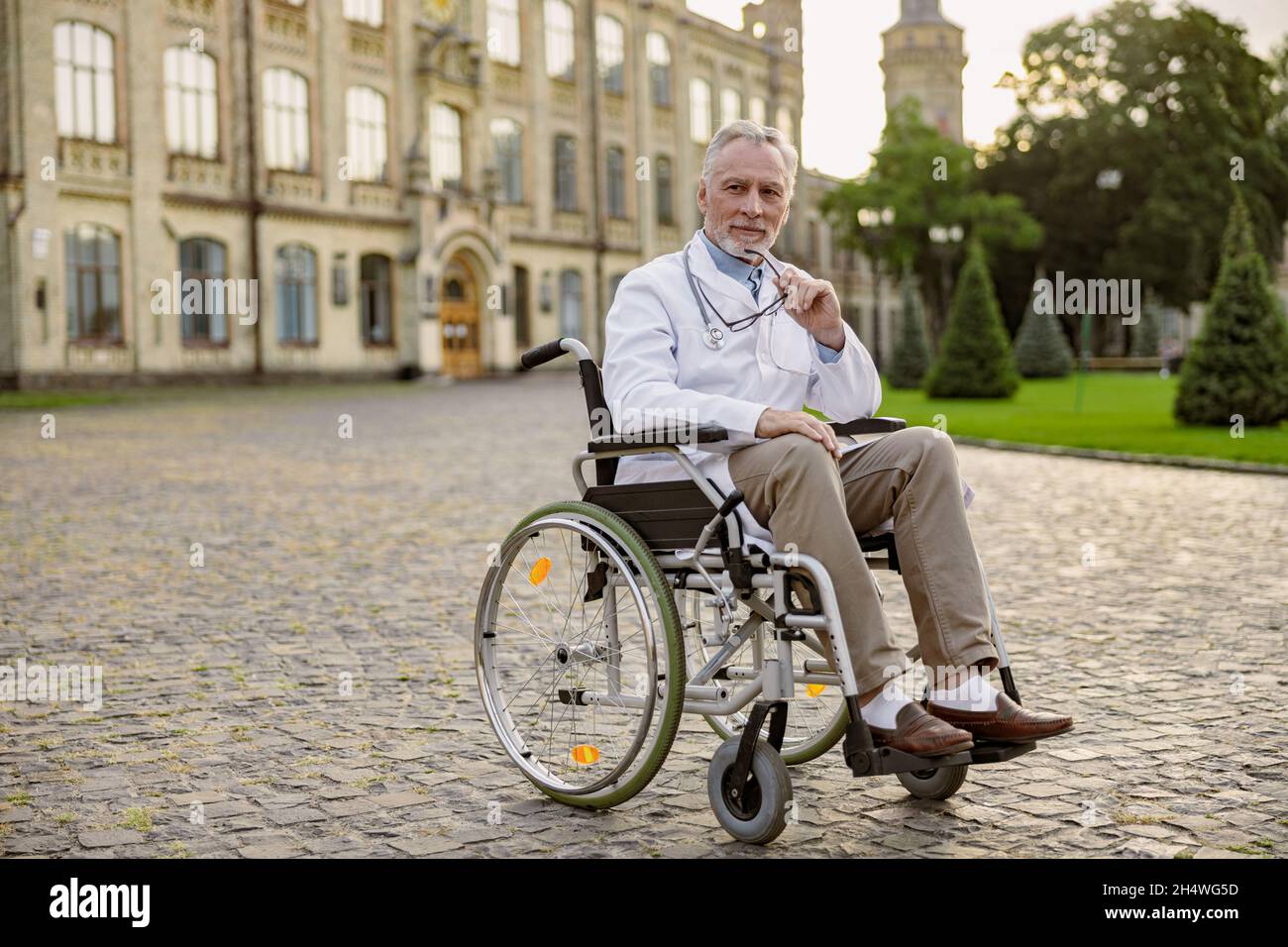 Full length shot of confident senior handicapped male doctor in ...