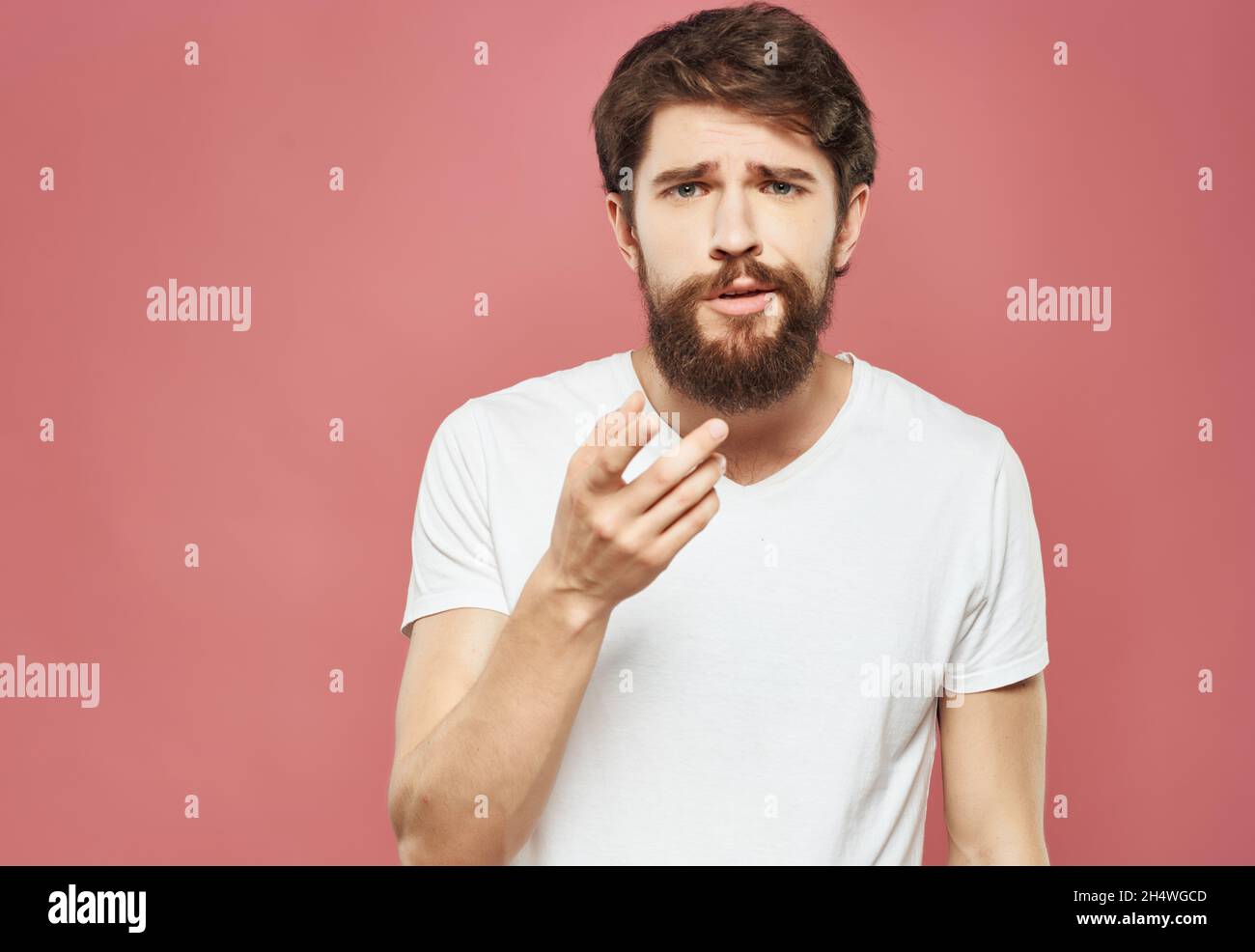 emotional man in a white t-shirt irritated facial expression Studio ...