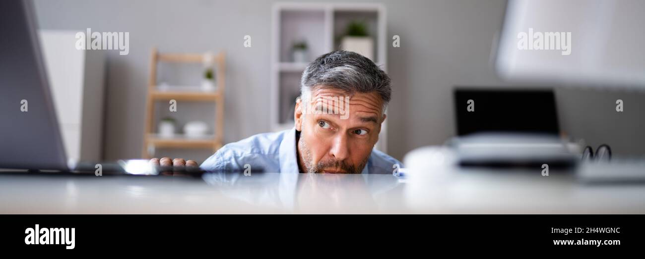Sneaky office hi-res stock photography and images - Alamy