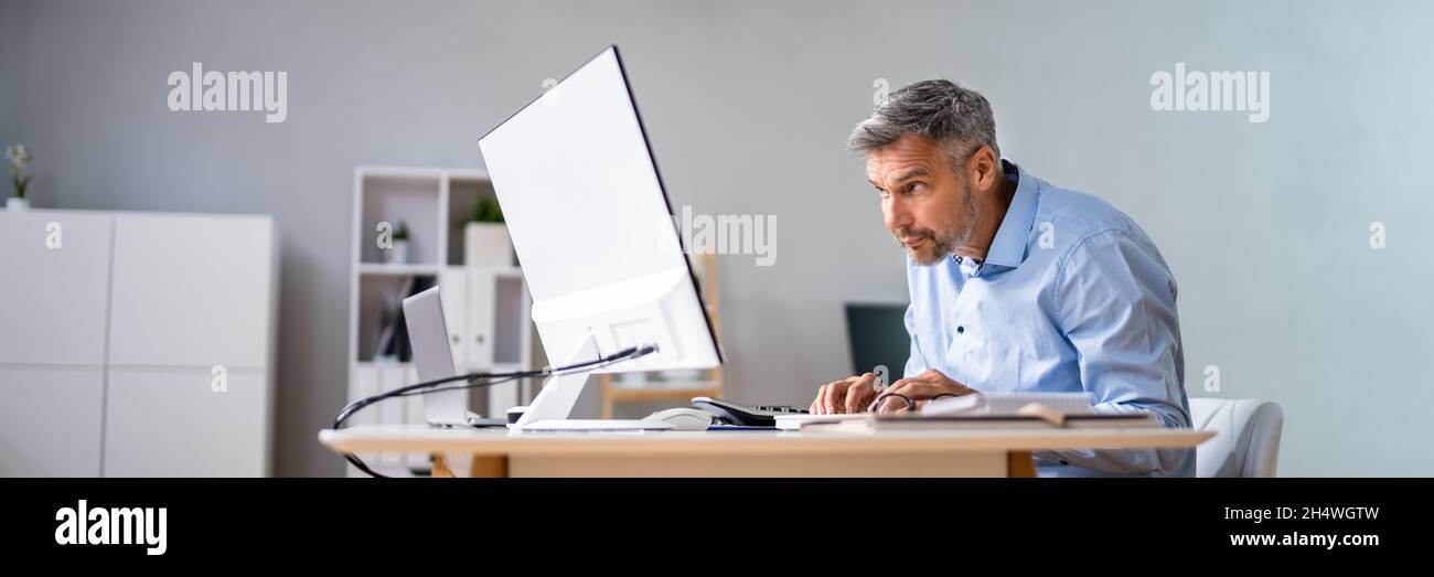 Man Sitting In Bad Posture Working On Computer In Office Stock Photo ...