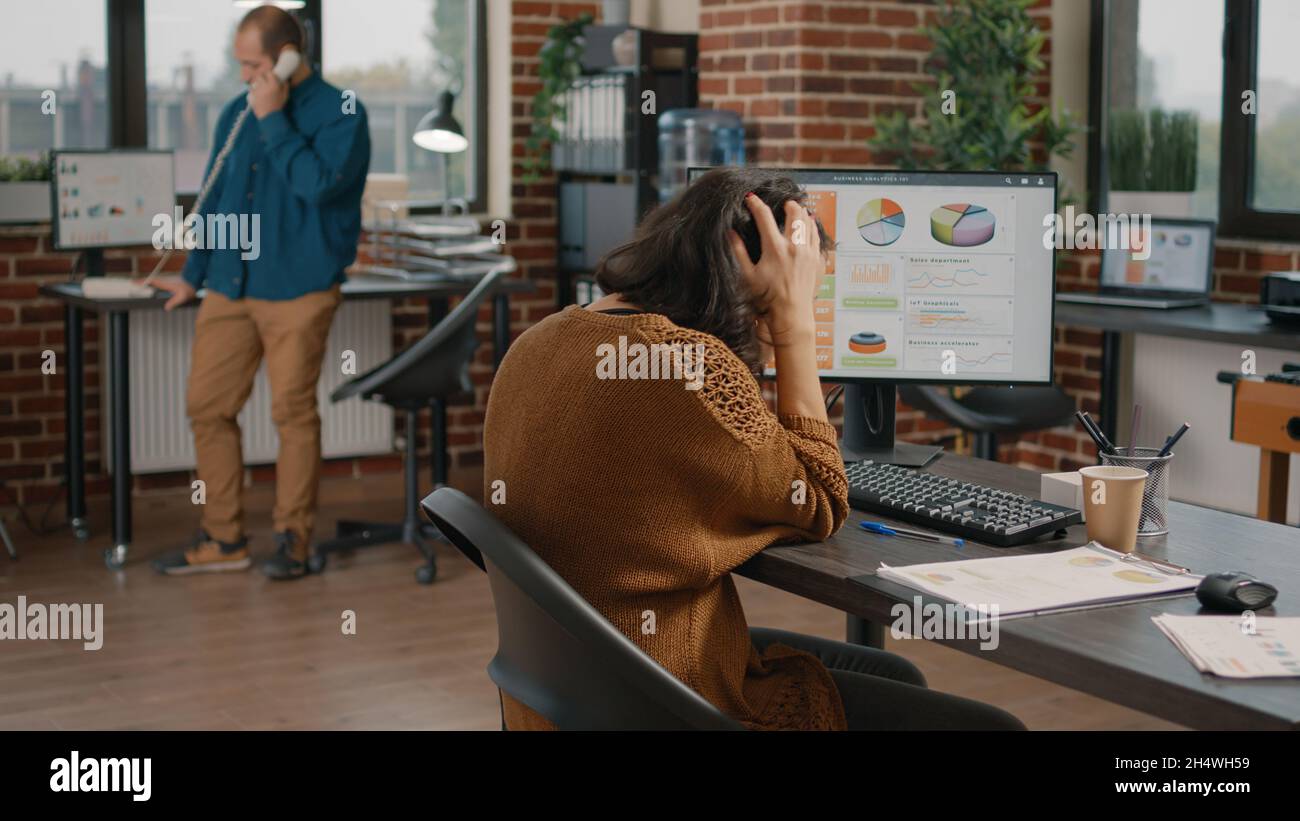 Stressed woman trying to design data charts on computer, planning ...