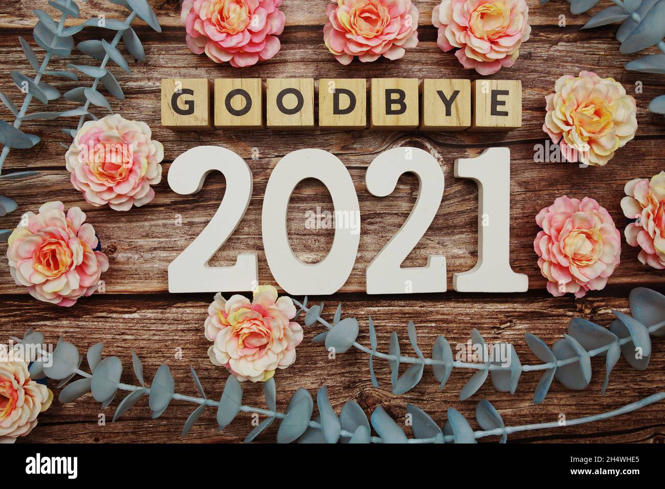 Goodbye 2021 alphabet letters with flower decorate on wooden background ...