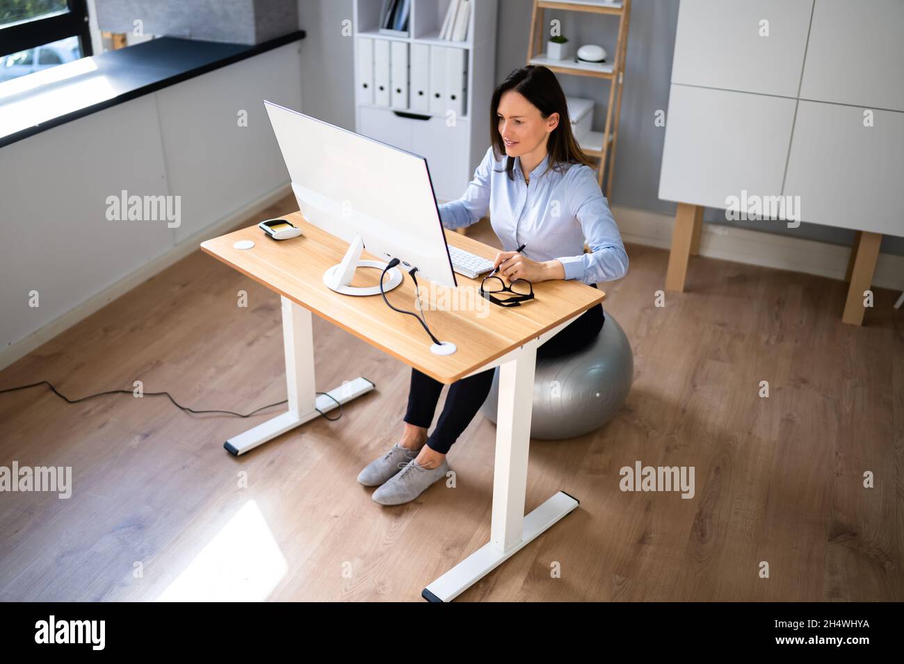 Female office using exercise ball hi-res stock photography and images ...