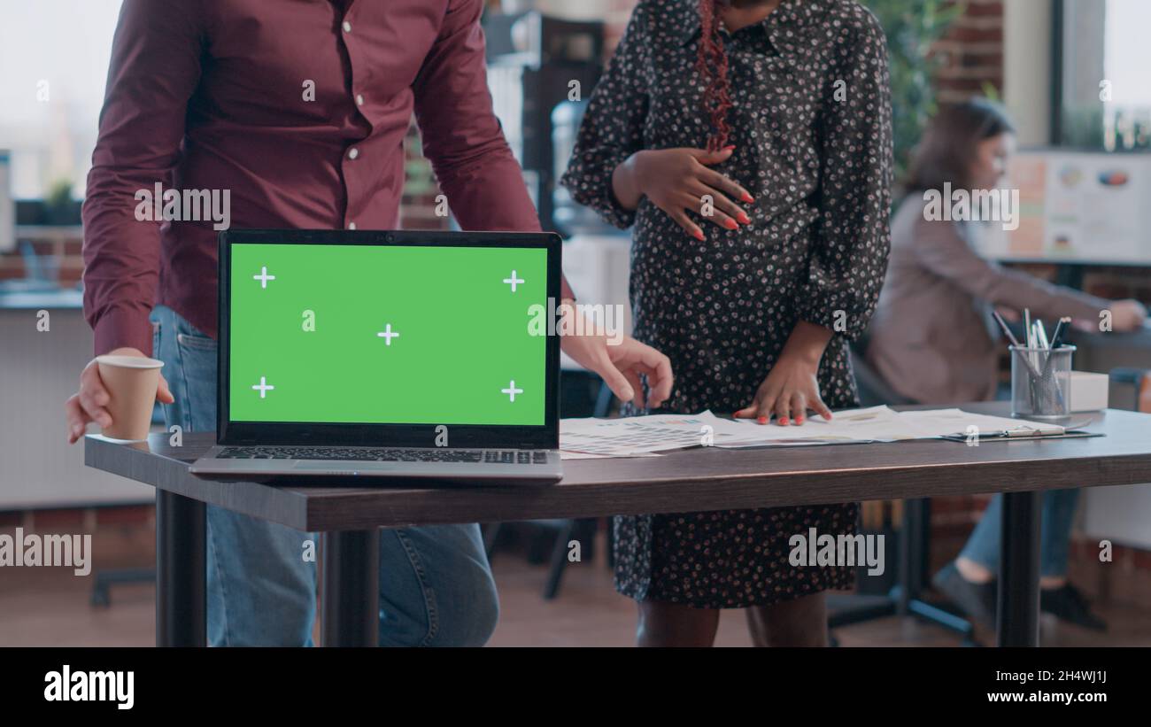 Close up of business people having laptop with horizontal green screen ...