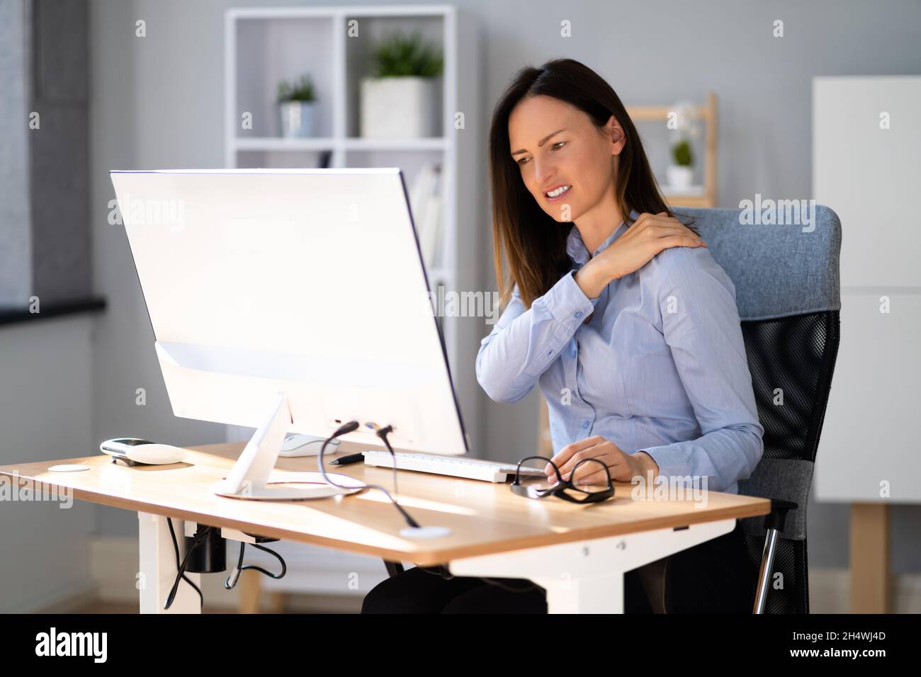 Bad Posture Neck Pain In Chair. Woman Suffering Stock Photo - Alamy