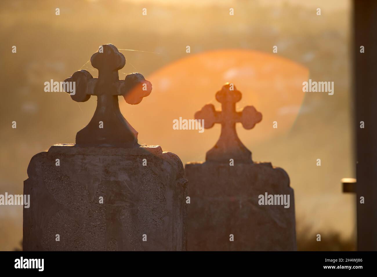 Headstones and grave sites in magic sunset at a cemtery Stock Photo - Alamy