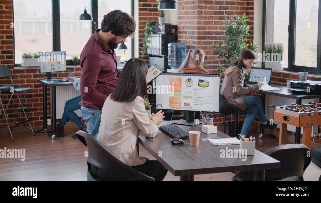 Child distracting multi ethnic colleagues in the office while her ...
