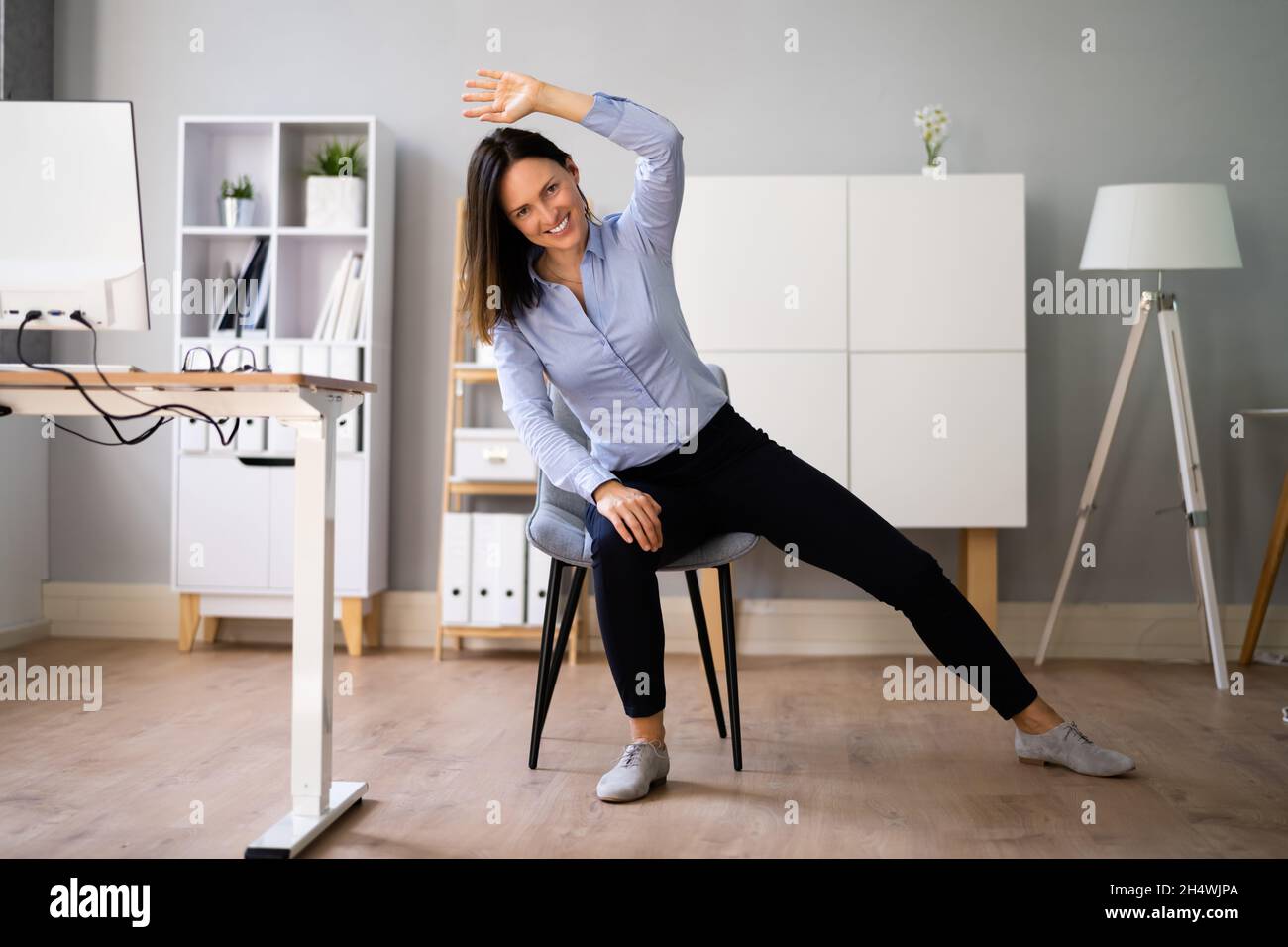 Stretch Exercise Workout Near Office Desk. Worker Stretching Stock ...