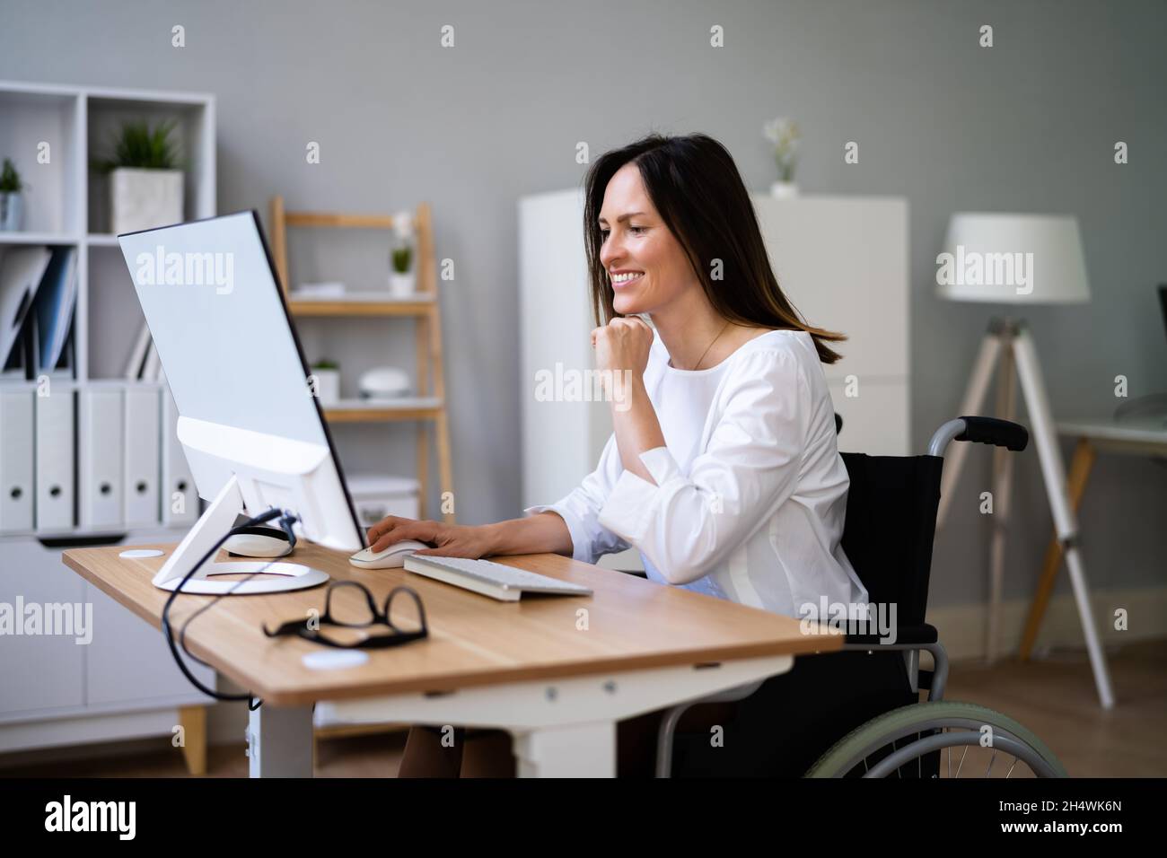 Person With Disability In Wheelchair Working On Computer Stock Photo ...