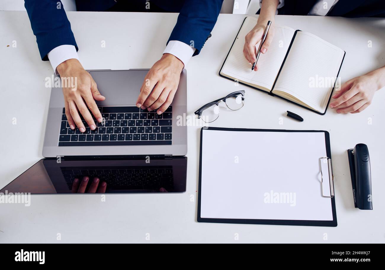 colleagues teamwork in the office with laptop officials Stock Photo - Alamy
